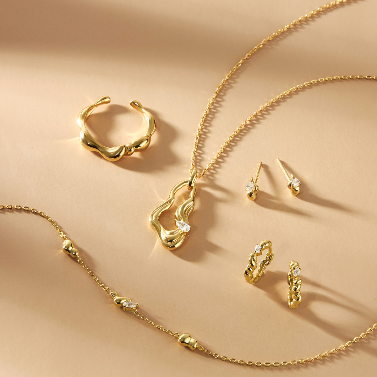 Gold Twisted Wave Huggie Hoop Earrings – Ania Haie US